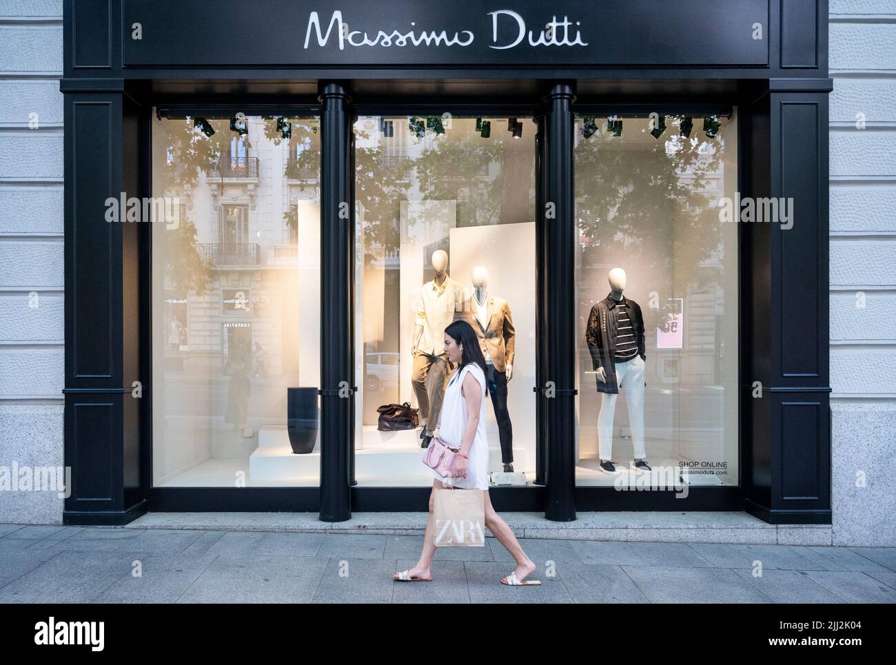 A pedestrian walks past the Spanish clothing manufacturing and brand ...
