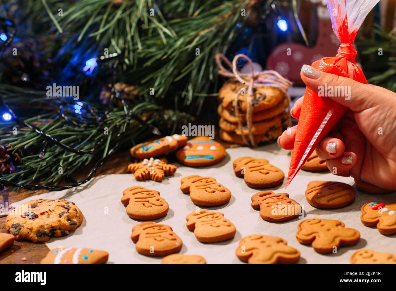 Decoration process of Christmas bakery Stock Photo - Alamy