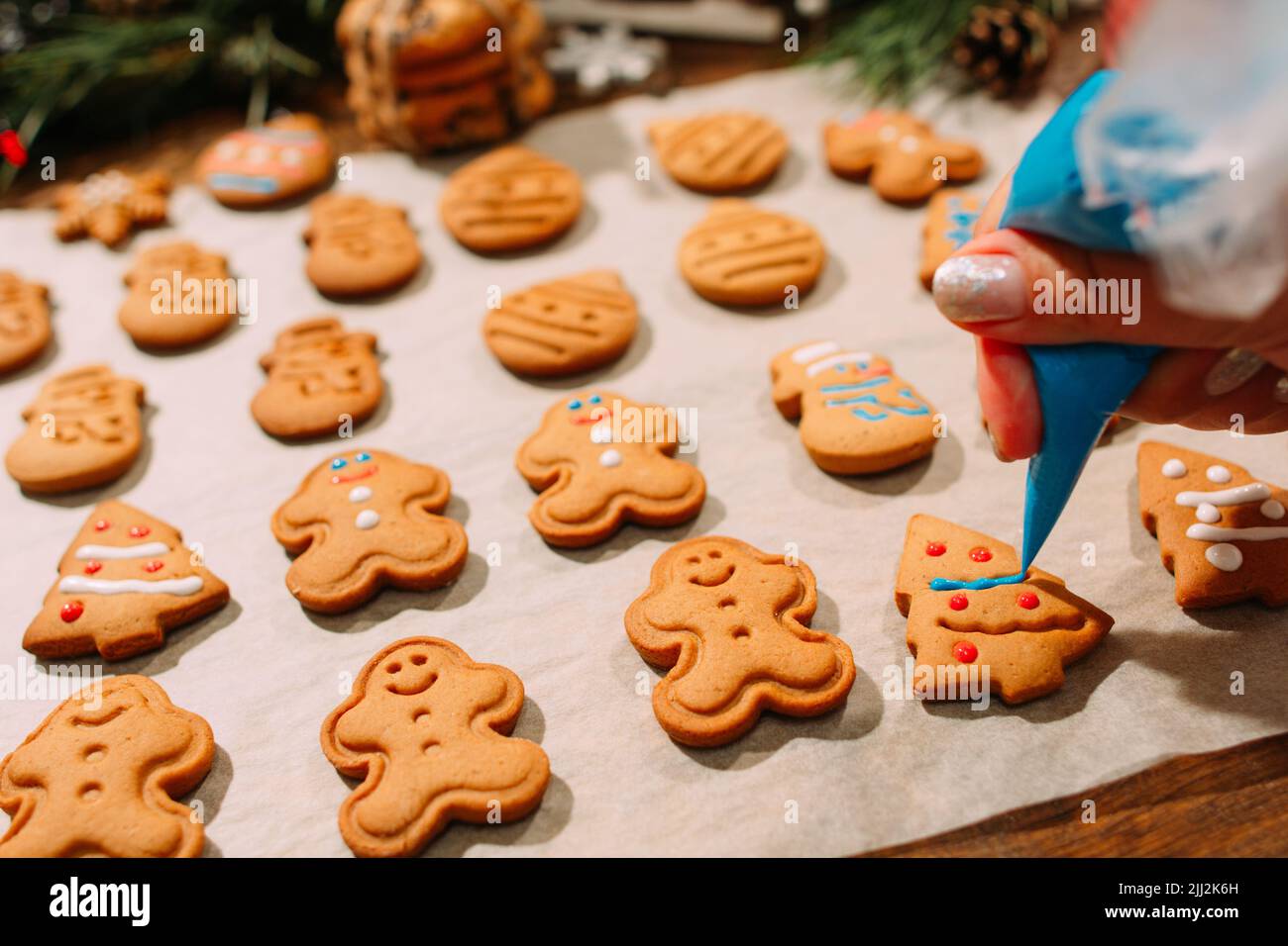 Decoration process of Christmas bakery Stock Photo - Alamy