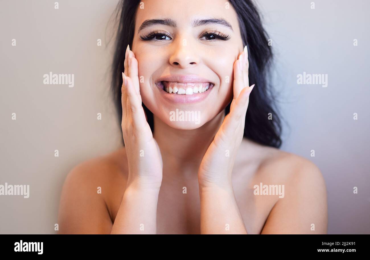 All things beauty. Portrait of a beautiful young woman applying ...