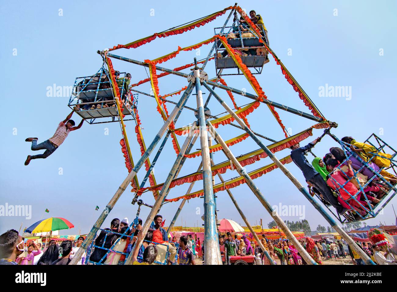 Ferris wheel, Nagordola in a traditional village fair in Bogra, Bangladesh. It's about 200 years ...