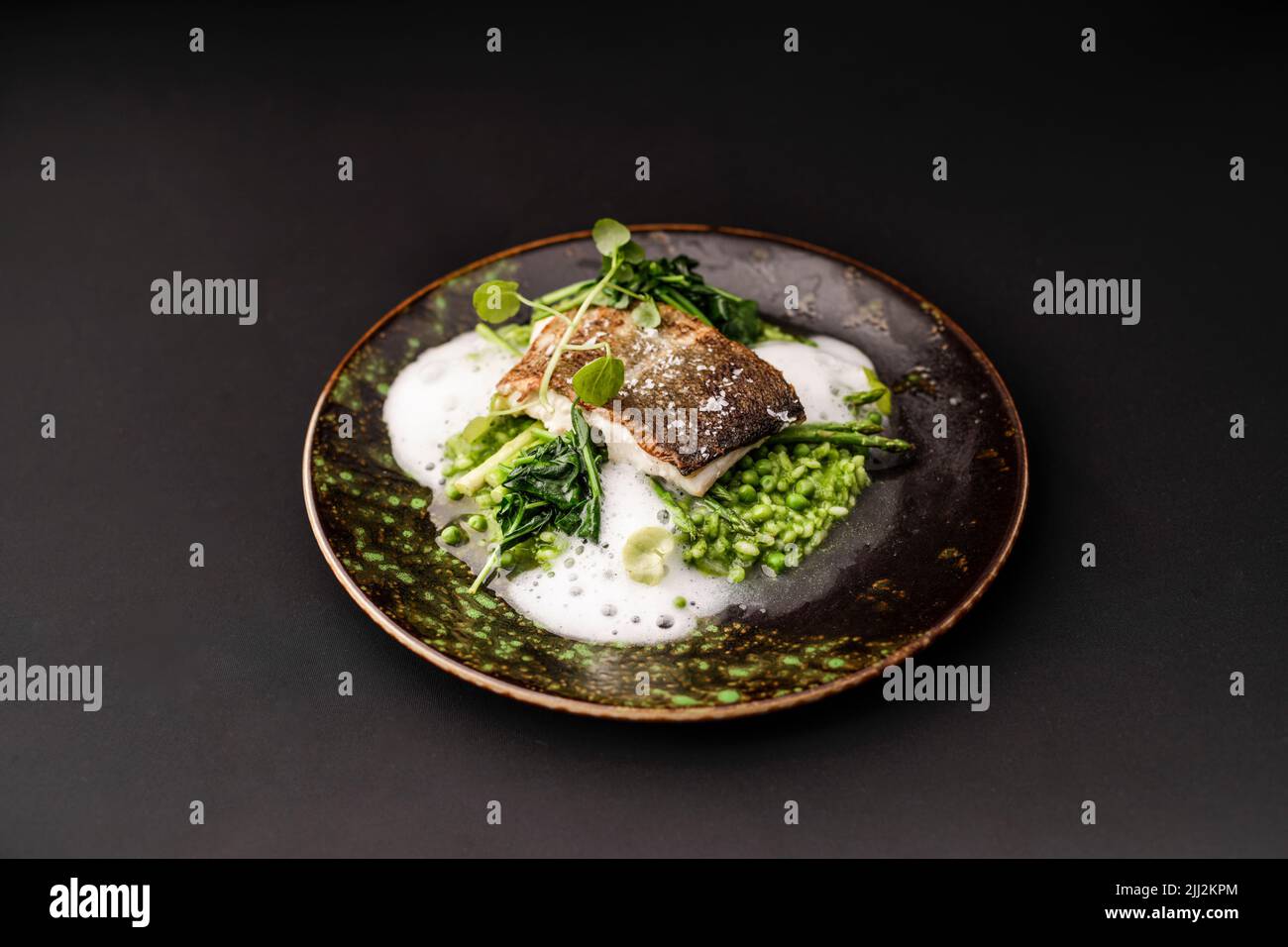 White fish baked on the skin with green asparagus Stock Photo - Alamy