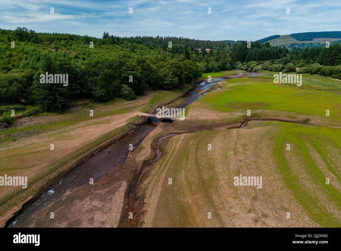 Aerial view of an old, usually submerged bridge at an empty reservoir ...