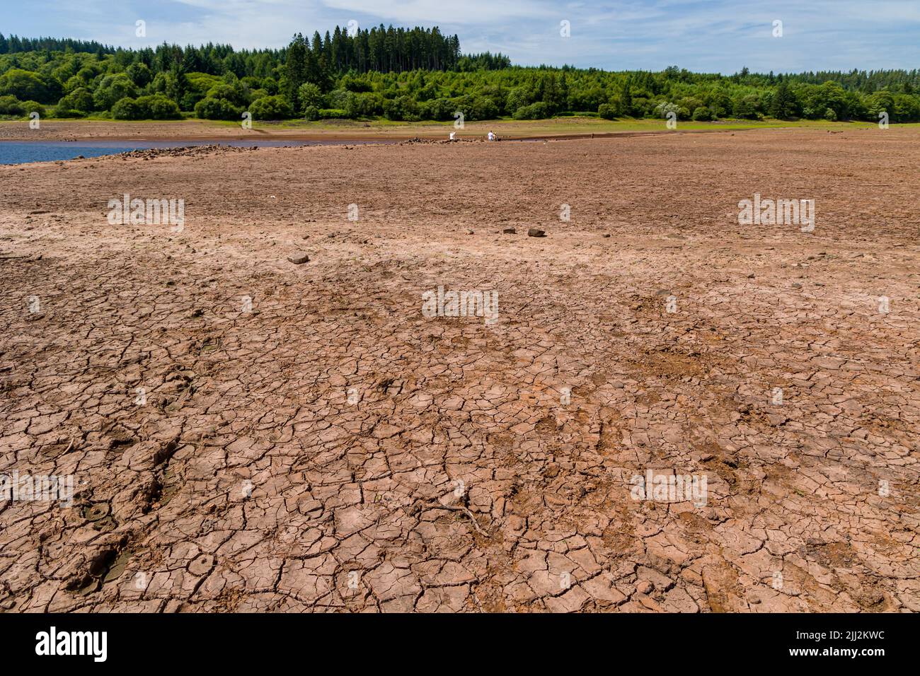 Baked, cracked, dry soil at a near empty reservoir during a heatwave ...