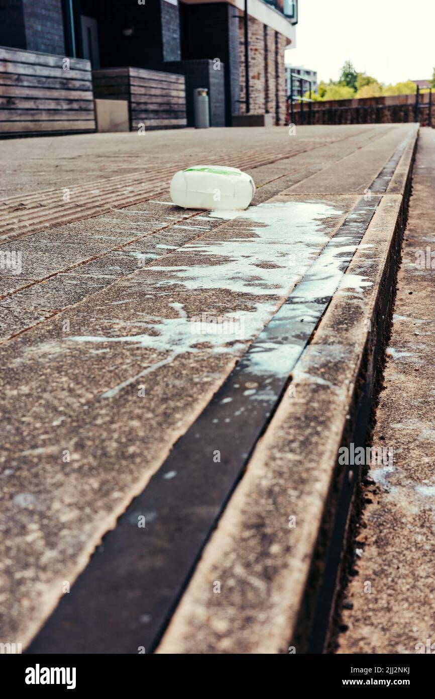 Milk spilled on a path (Jul22 Stock Photo - Alamy