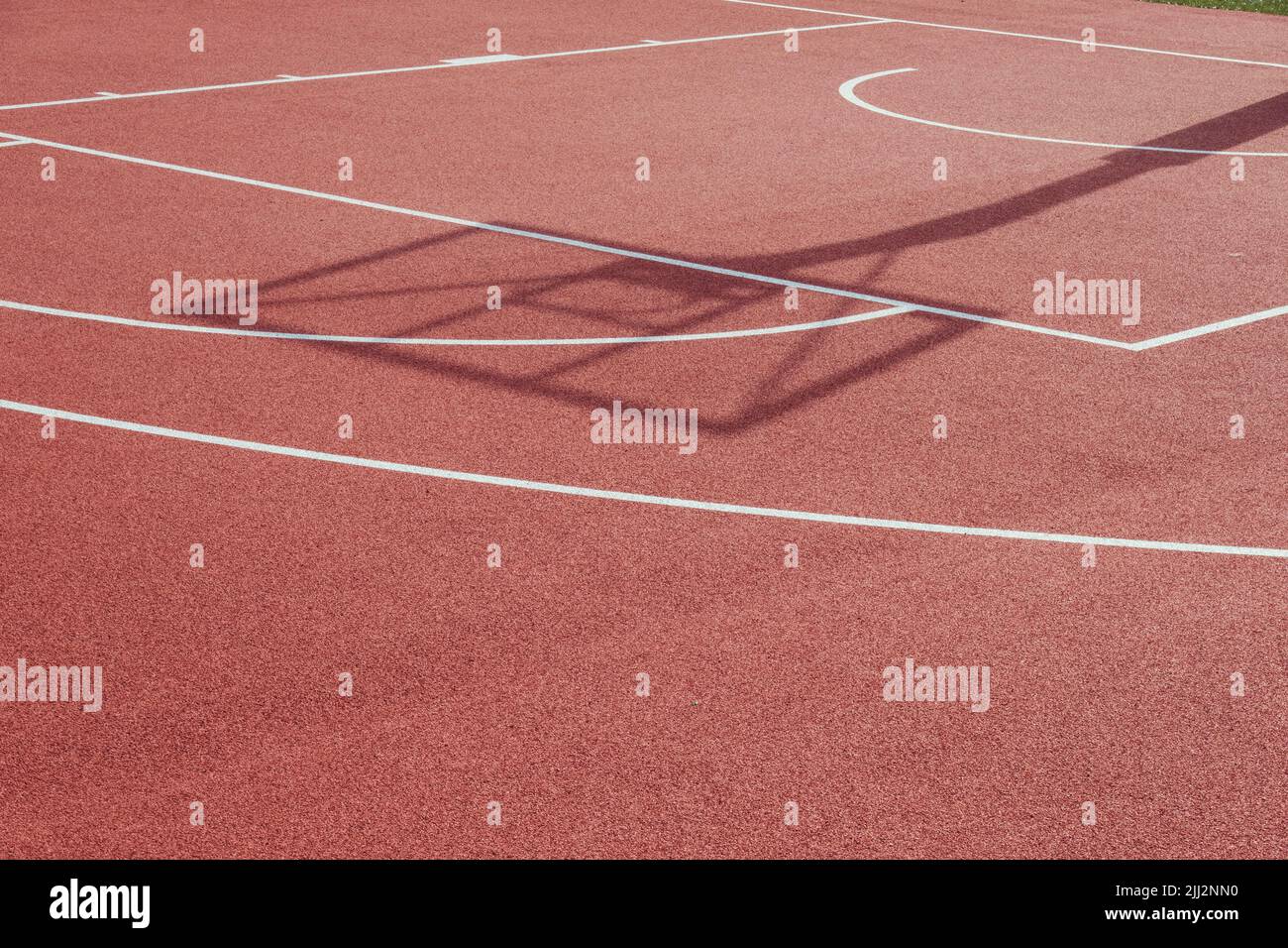 Shadow of the rack with shield and basketball ring on orange basketball ...