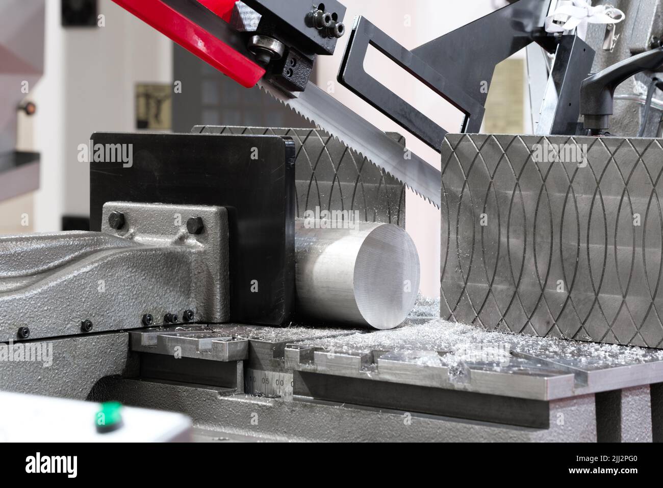 Automatic bandsaw sawing metal workpiece, industrial concept Stock ...