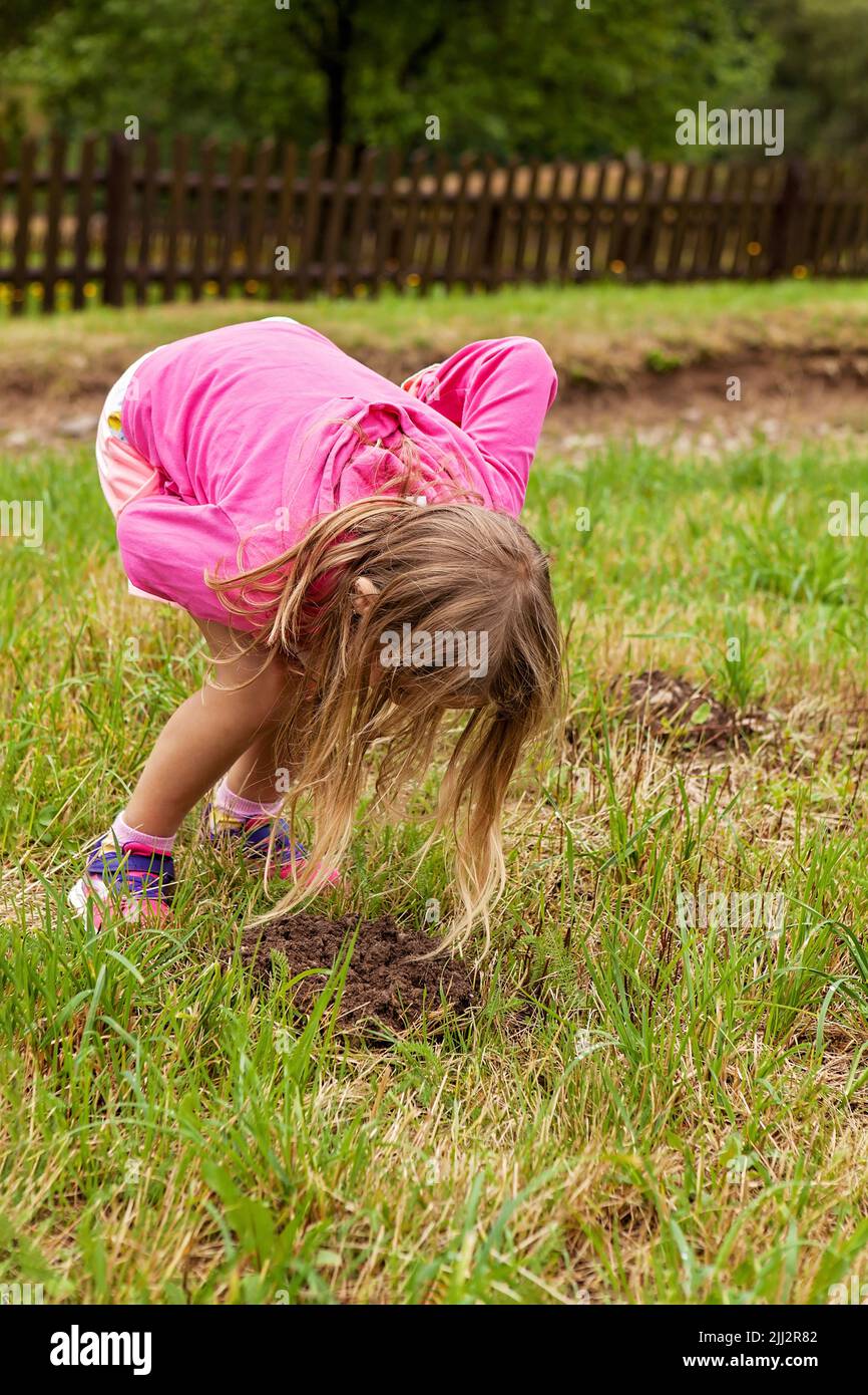 Bending down hi-res stock photography and images - Alamy