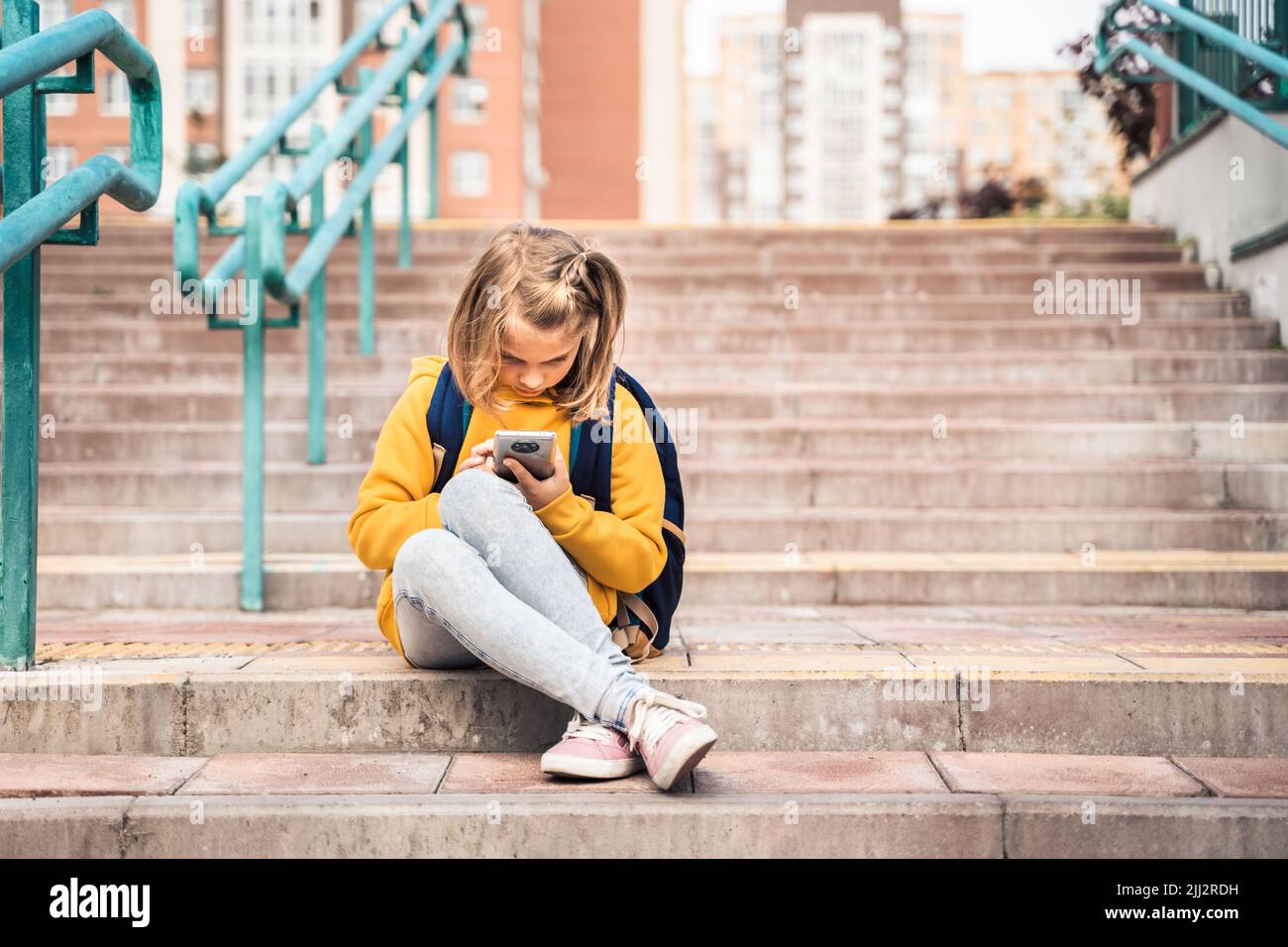 Back to elementary, primary school. Little girl with backpack,mobile ...