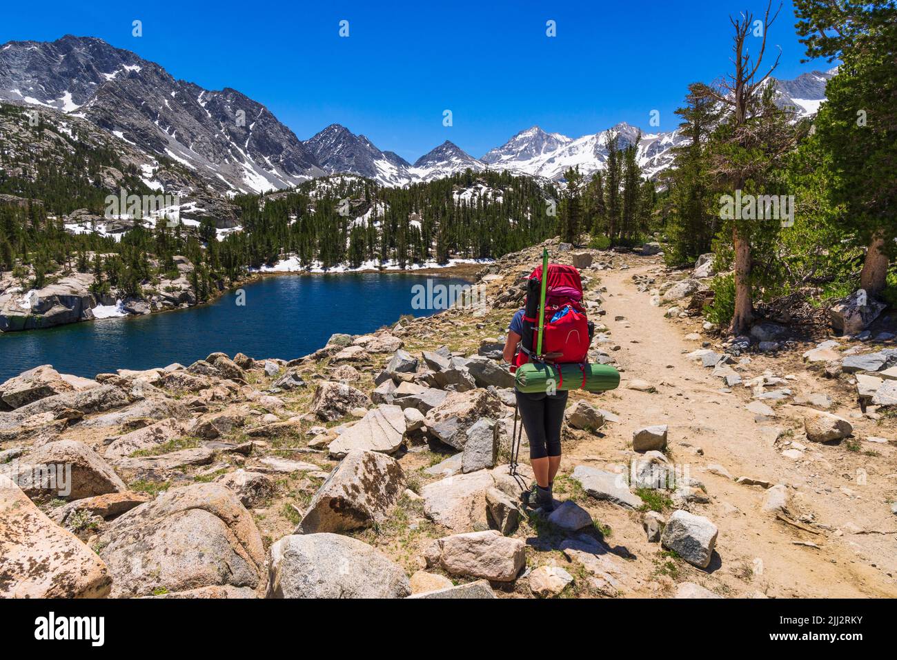 Woman backpacking along Box Lake in Little Lakes Valley, John Muir ...