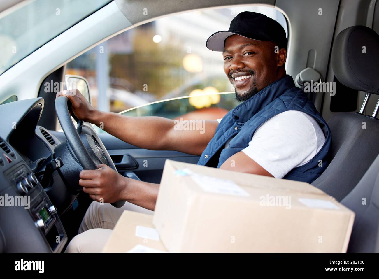Nothing can slow me down. young man delivering a package while sitting ...