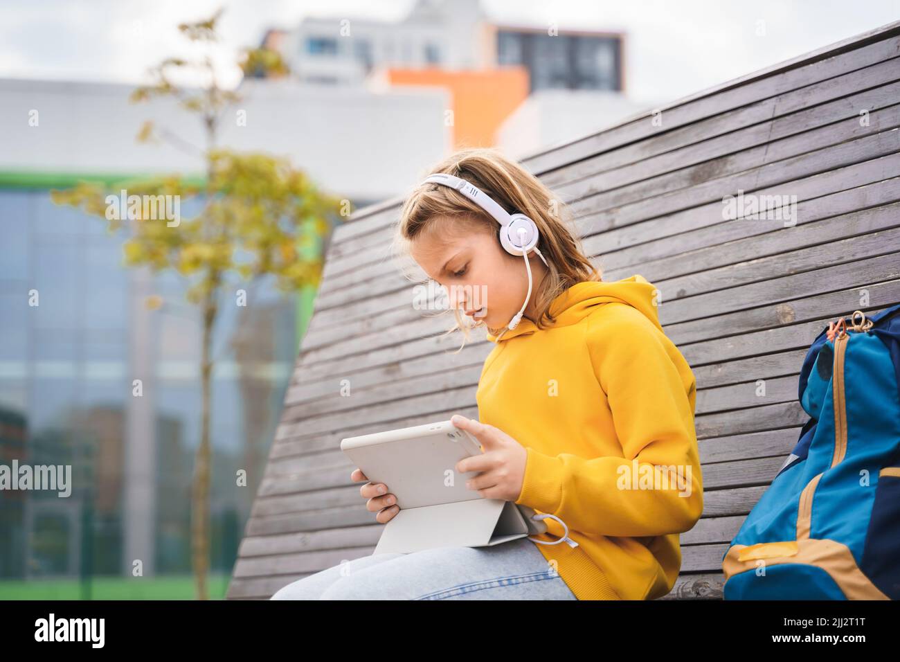 Little girl in headphones, headset with table. Study, online conference ...