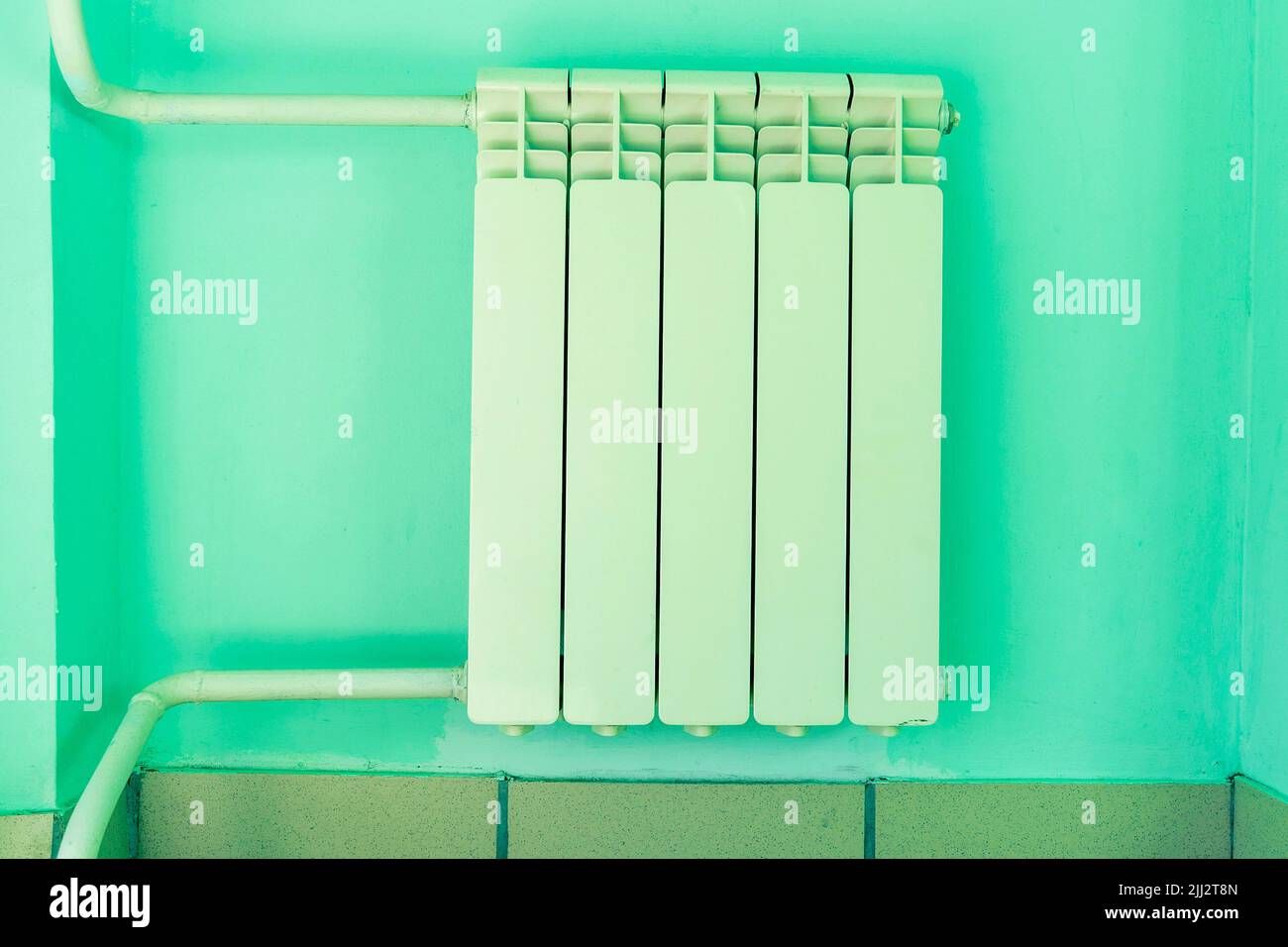 sectional radiator of the heater on the wall in room, heating pipes ...