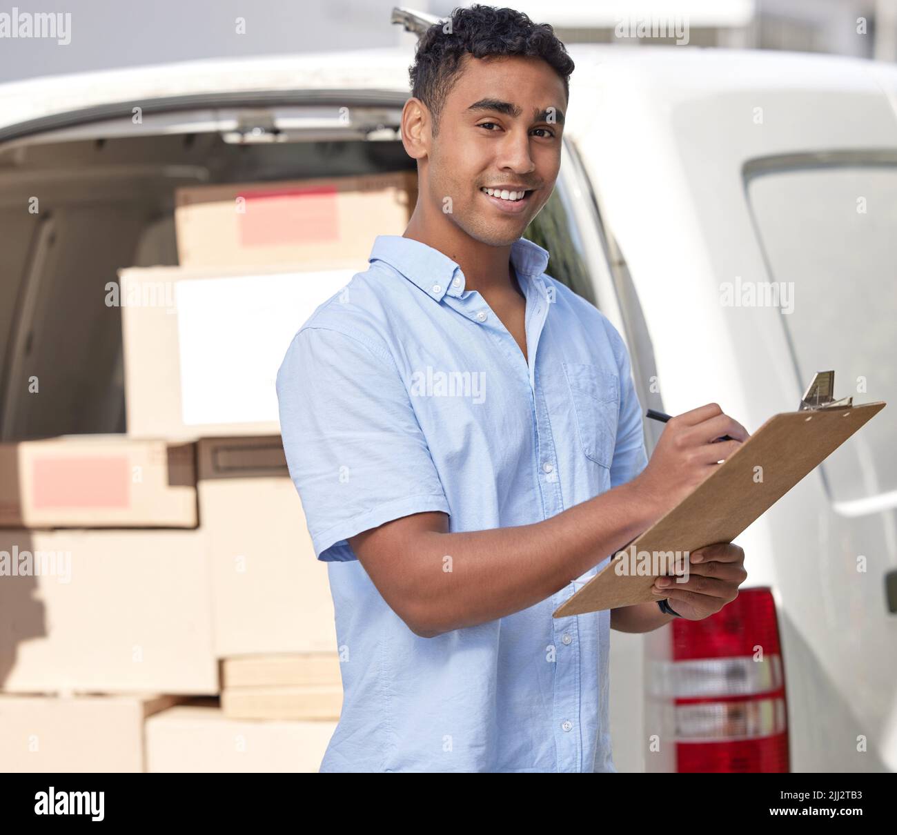 All parcels are safe and sound. Portrait of a young delivery man ...