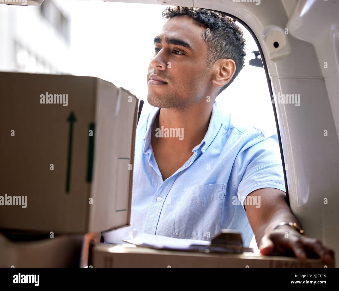 Its all here, safe and sound. a young delivery man using a clipboard ...