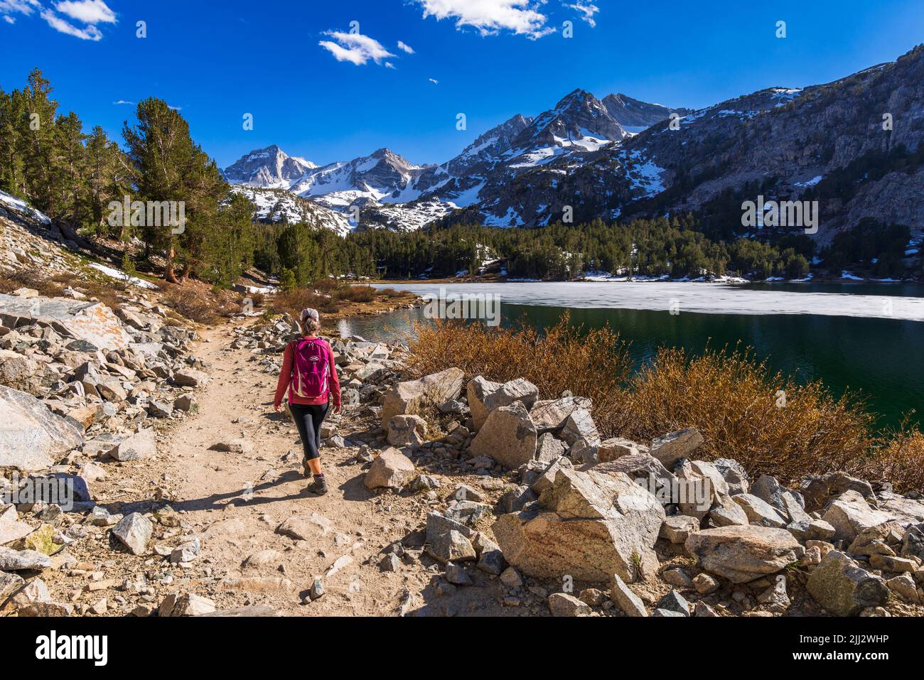 Woman hiking at Long Lake in Little Lakes Valley, John Muir Wilderness ...