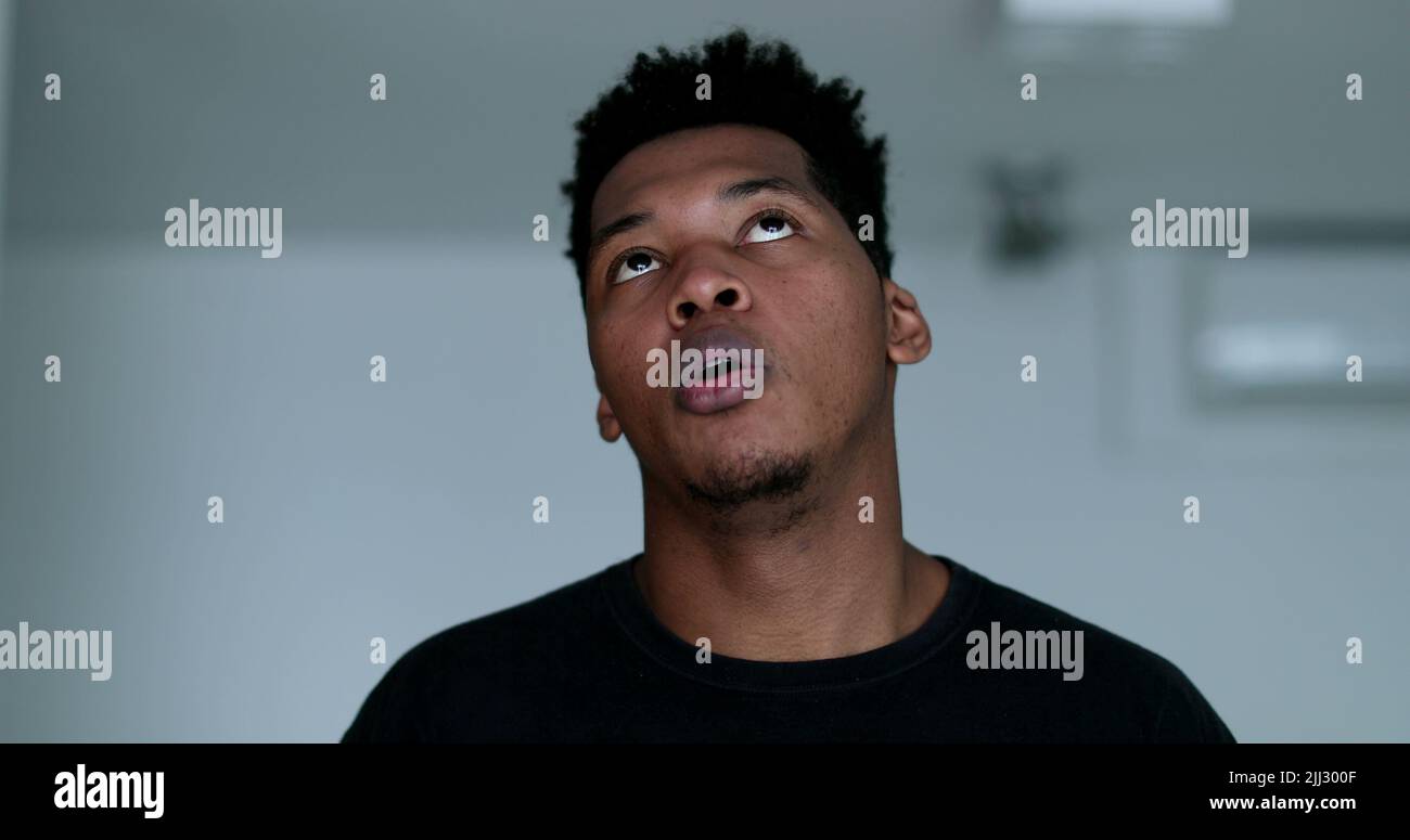 Annoyed bored black man rolling eyes Stock Photo - Alamy