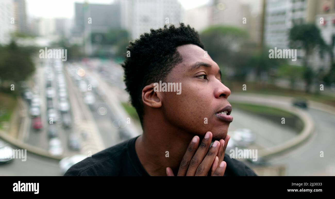 Anxious young black African man suffering in city Stock Photo - Alamy