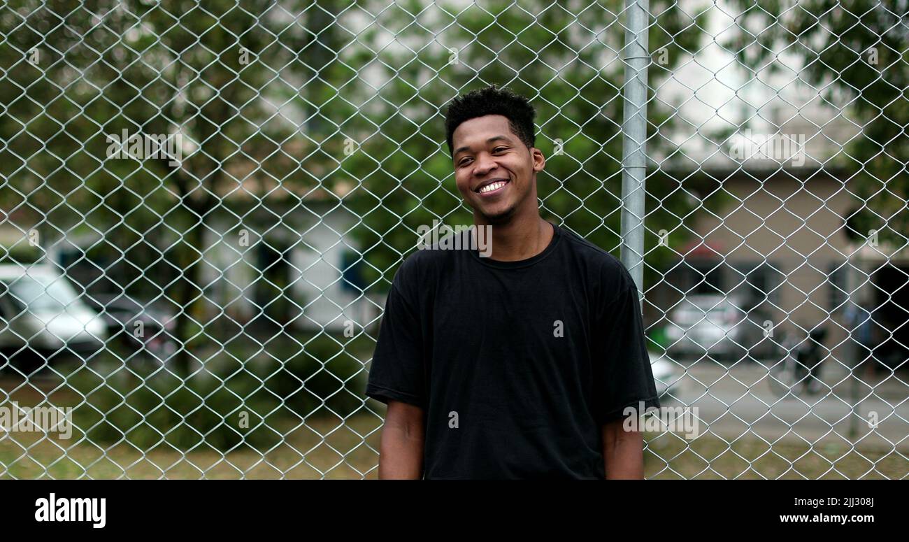 Black man shrugging. Confused African person showing doubt and smiling ...