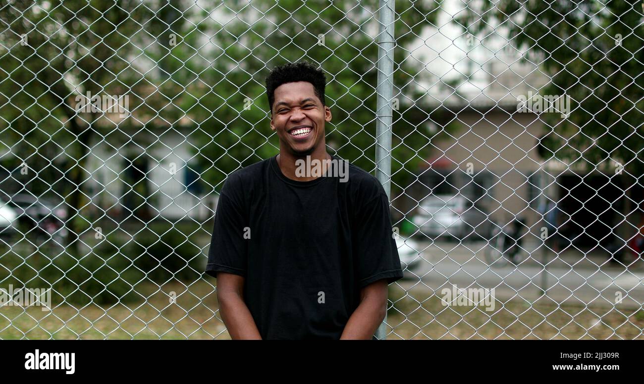 Black man shrugging. Confused African person showing doubt and smiling ...