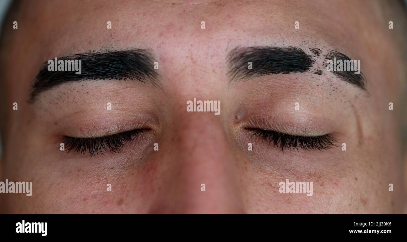 Close-up hispanic eyes closing and opening eyes in meditation. Smiling ...