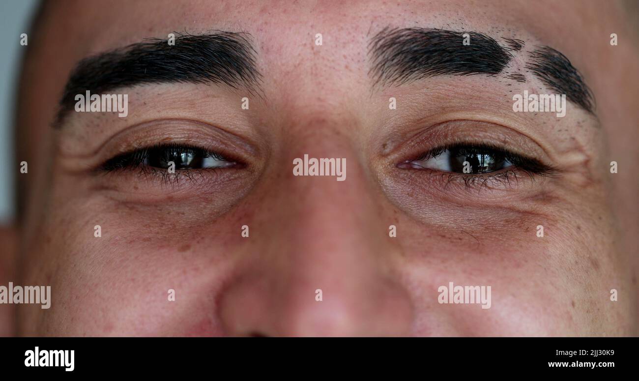 Close-up hispanic eyes closing and opening eyes in meditation. Smiling ...