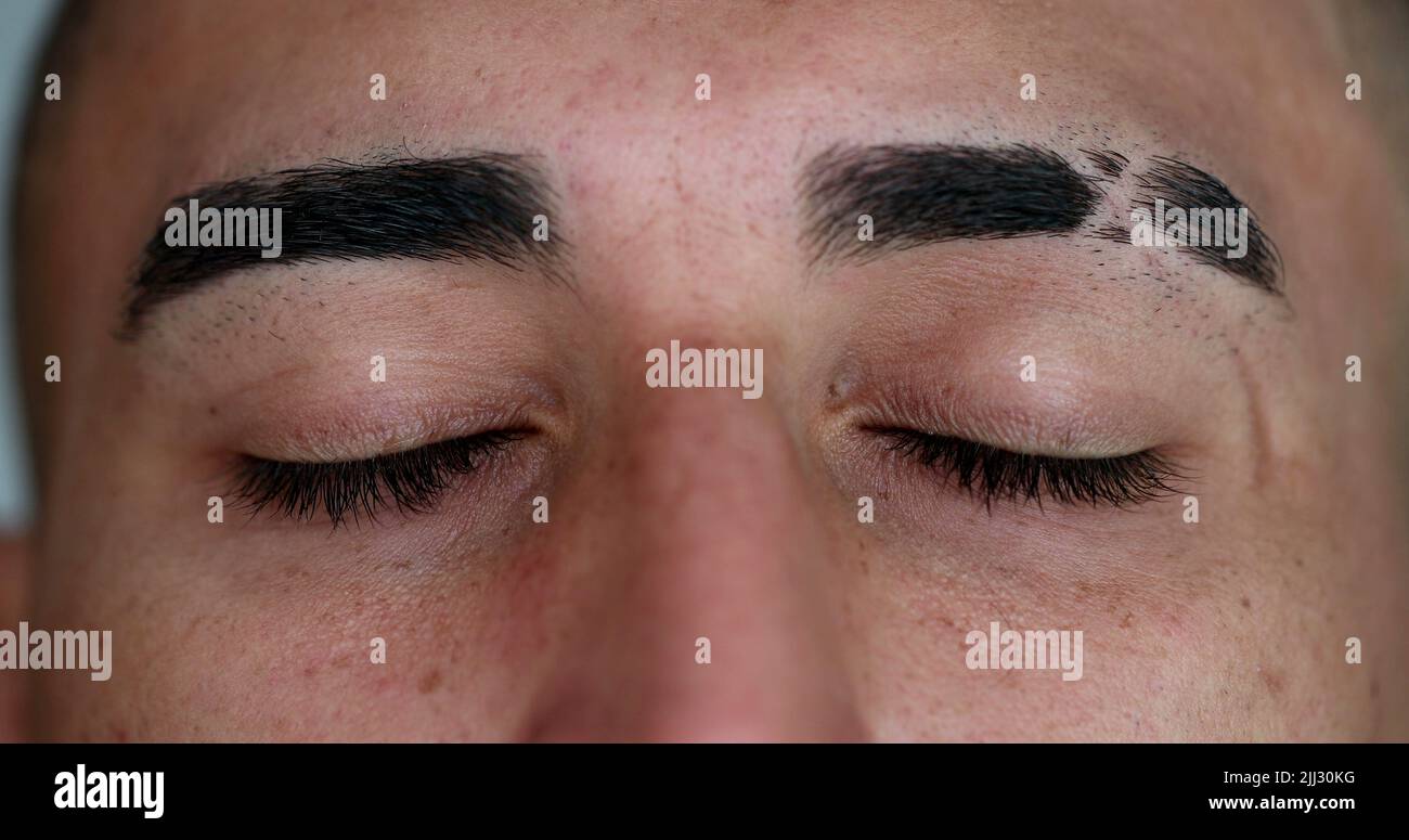 Close-up hispanic eyes closing and opening eyes in meditation. Smiling ...