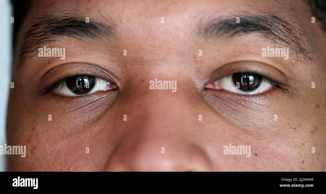 Close-up young black man eyes looking at camera, macro african person face Stock Photo - Alamy