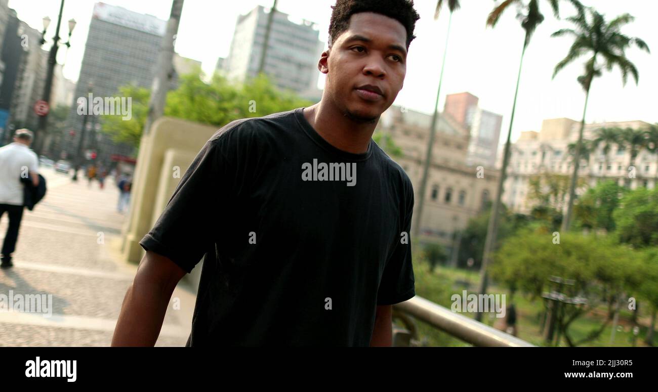 Cool young black man in downtown city. African guy standing outside ...