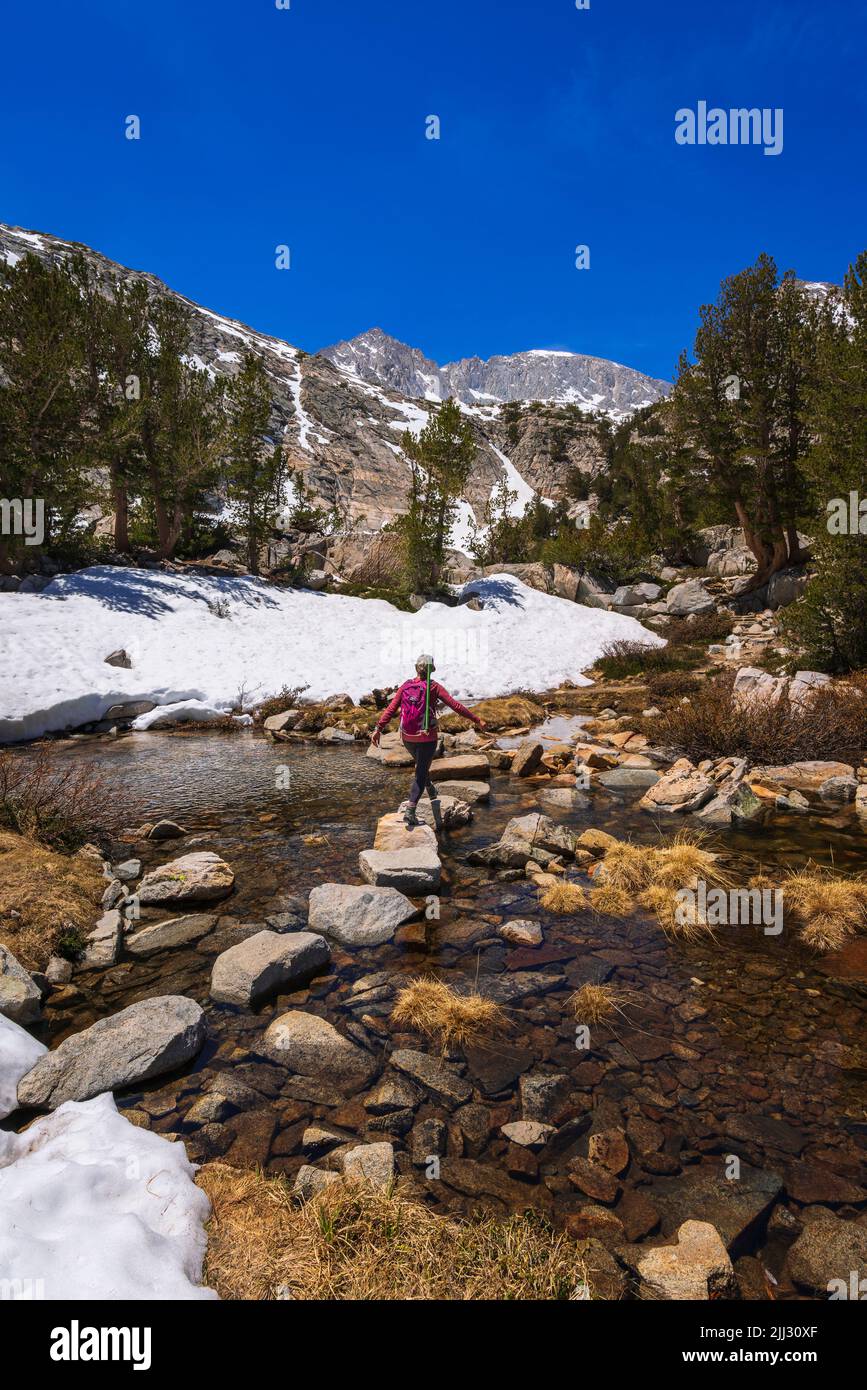 Hiker crossing Rock Creek under Mount Abbot, Little Lakes Valley, John ...