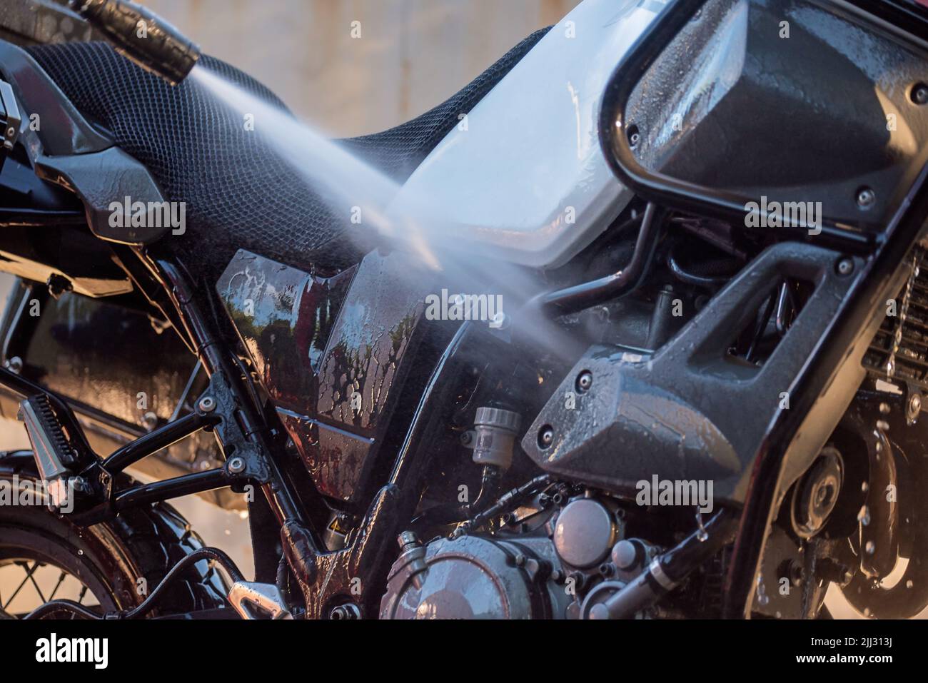 A clean wet motorcycle of the enduro class. Wet bike. Car wash Stock ...