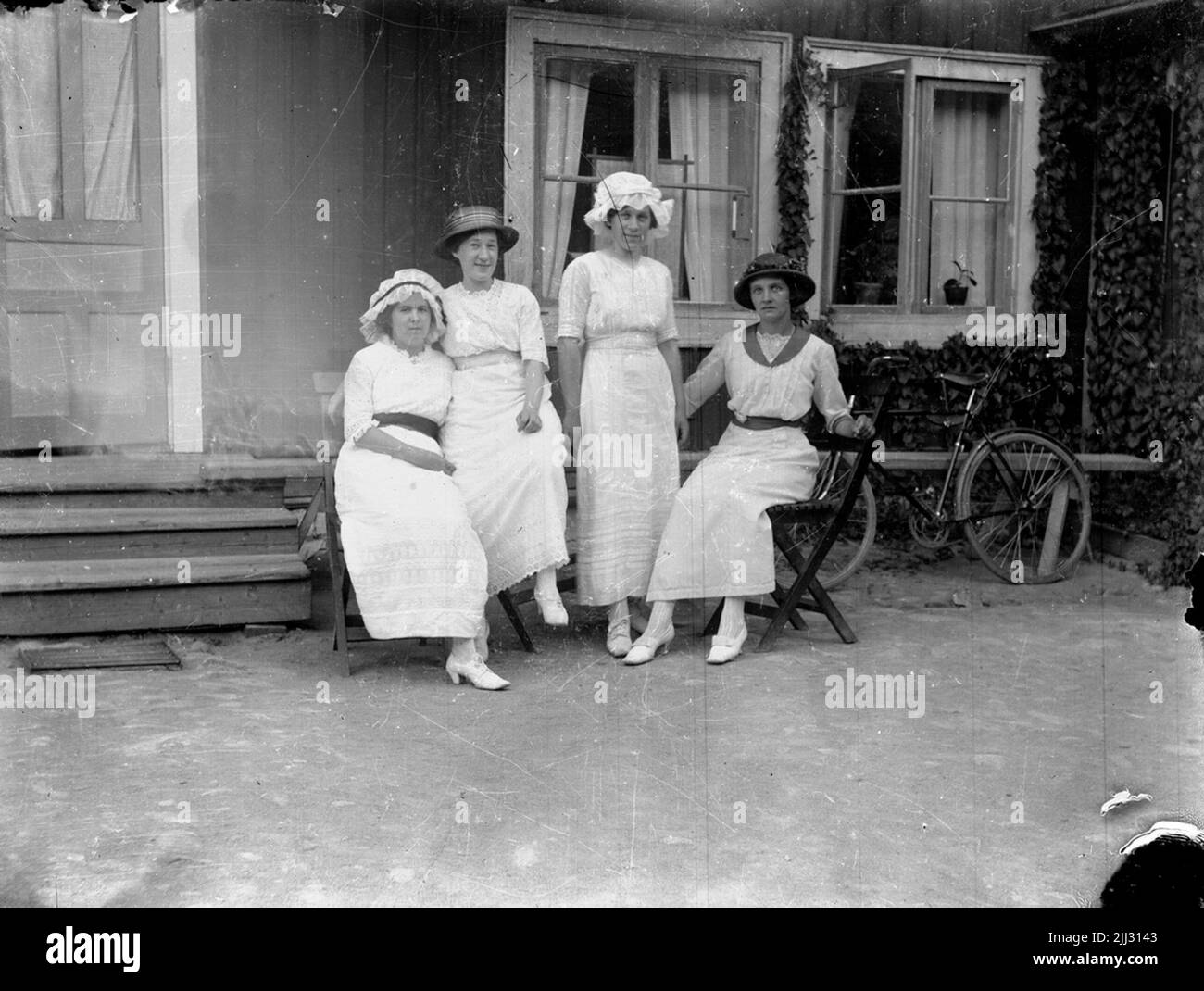 Group four young women in front of a residential house Stock Photo - Alamy