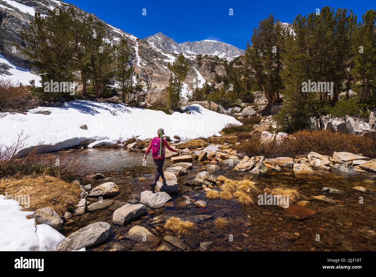 Hiker crossing Rock Creek under Mount Abbot, Little Lakes Valley, John ...