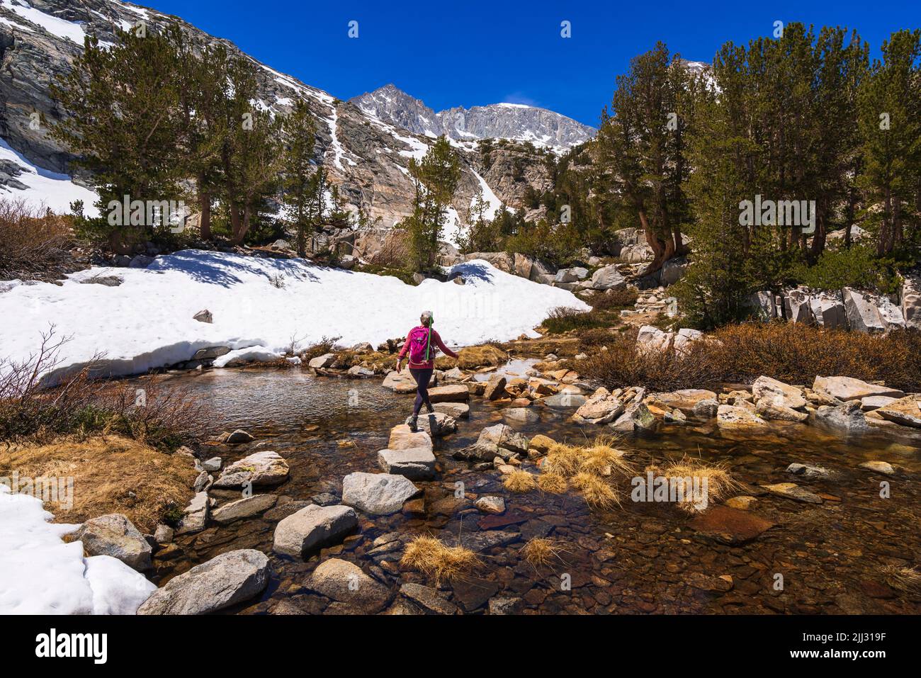 Hiker crossing Rock Creek under Mount Abbot, Little Lakes Valley, John ...