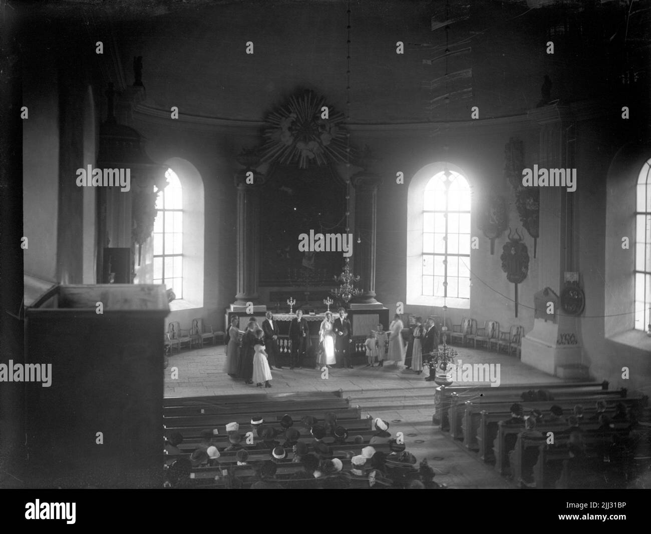 Church interior, wedding, bridal couple, wedding guests and a priest ...