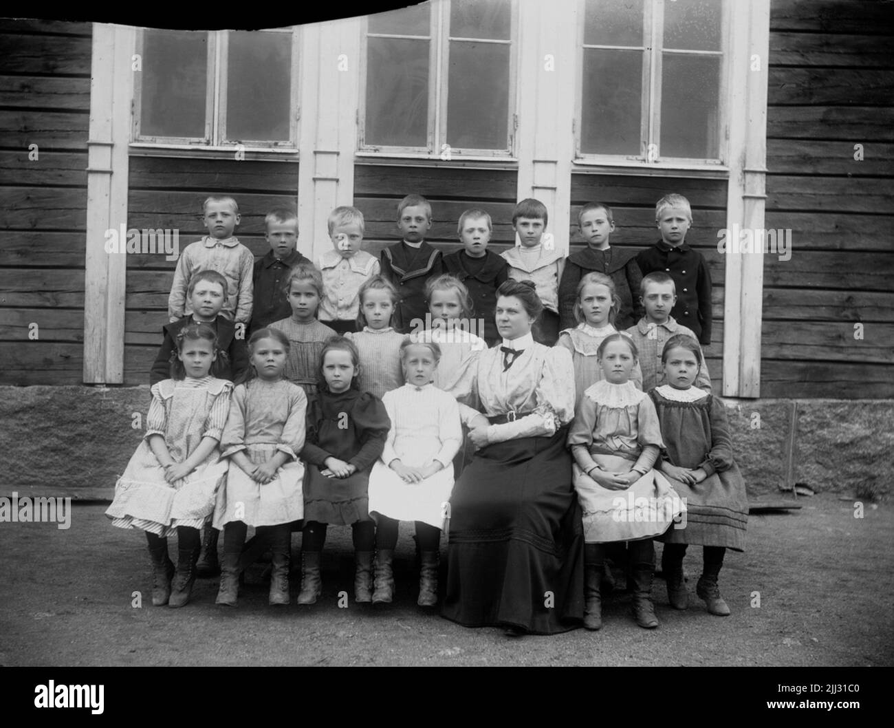 Schoolchildren with teacher. School building Stock Photo - Alamy