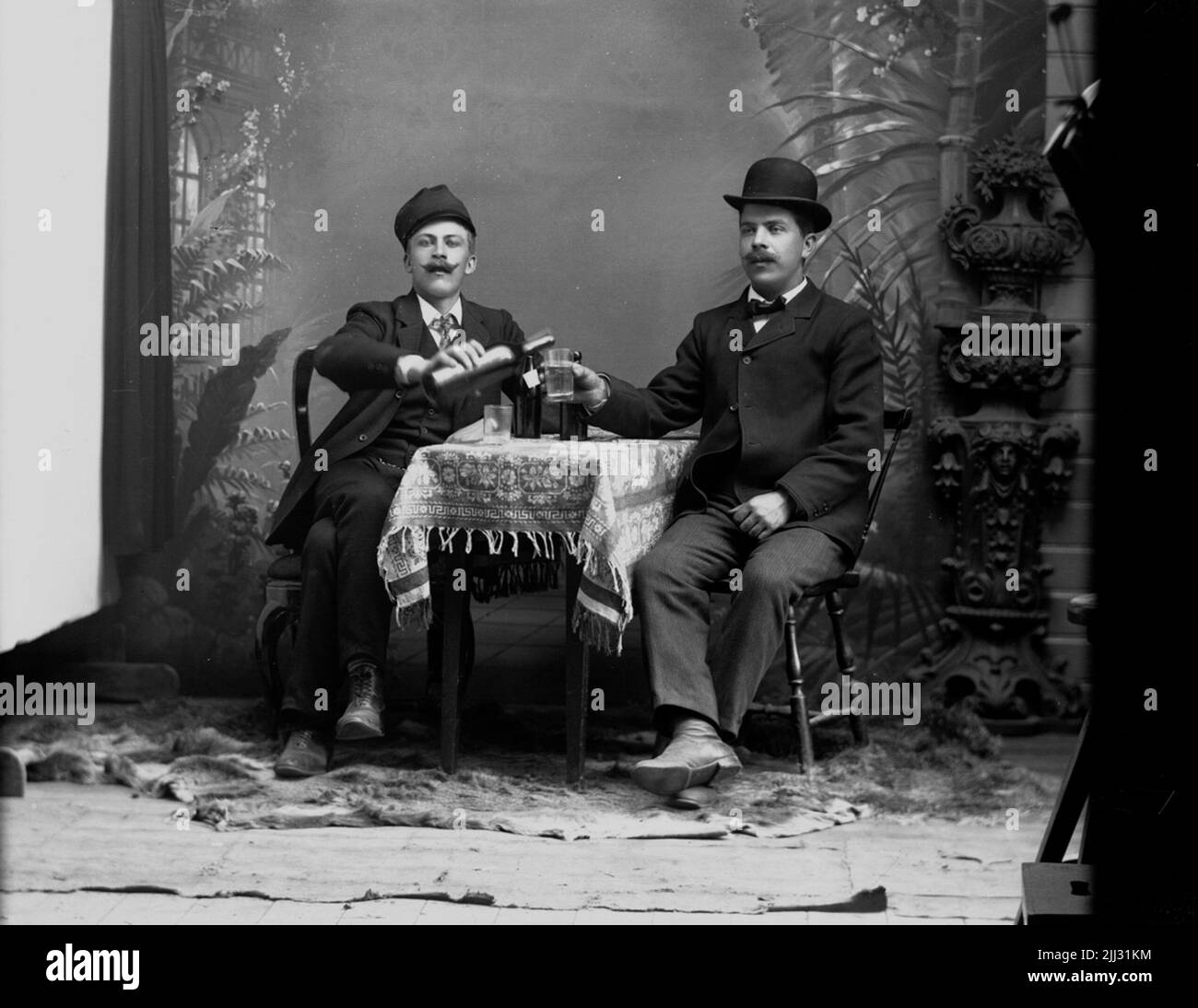 Group men seated table Black and White Stock Photos & Images - Alamy