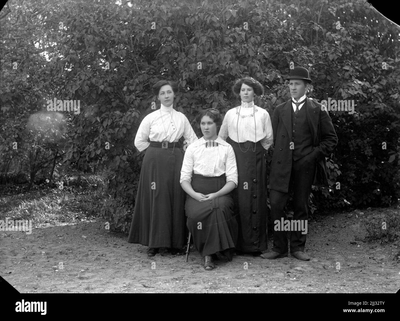 Four men sitting Black and White Stock Photos & Images - Alamy