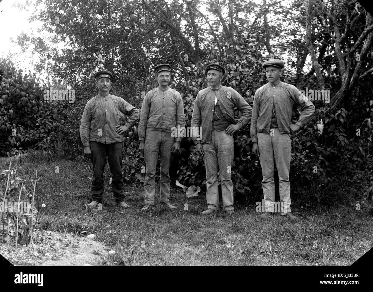 Four men posing Black and White Stock Photos & Images - Alamy
