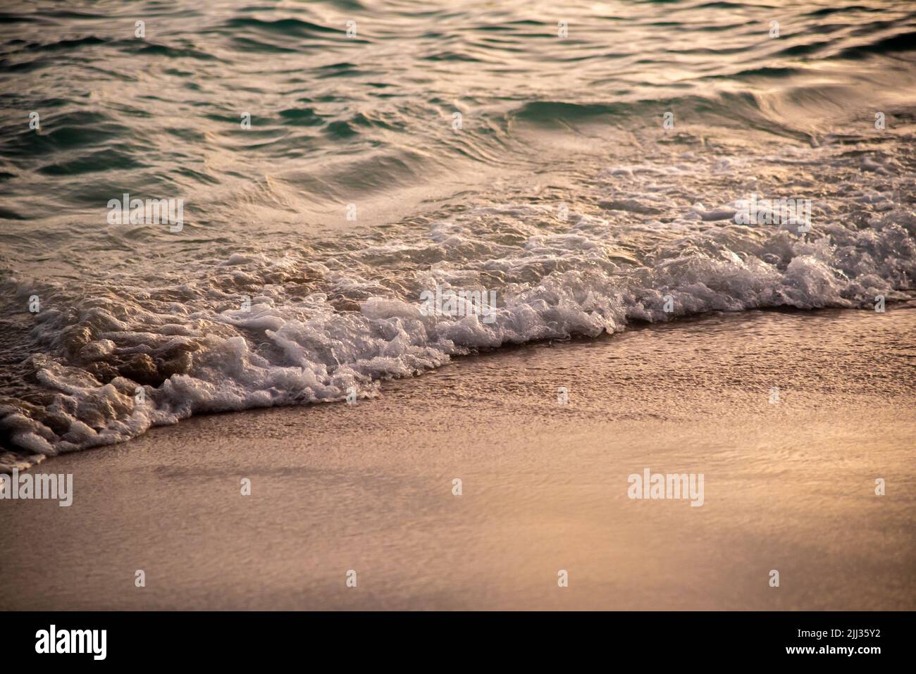 Beach shoreline with white waves breaking on the shoreline Stock Photo ...
