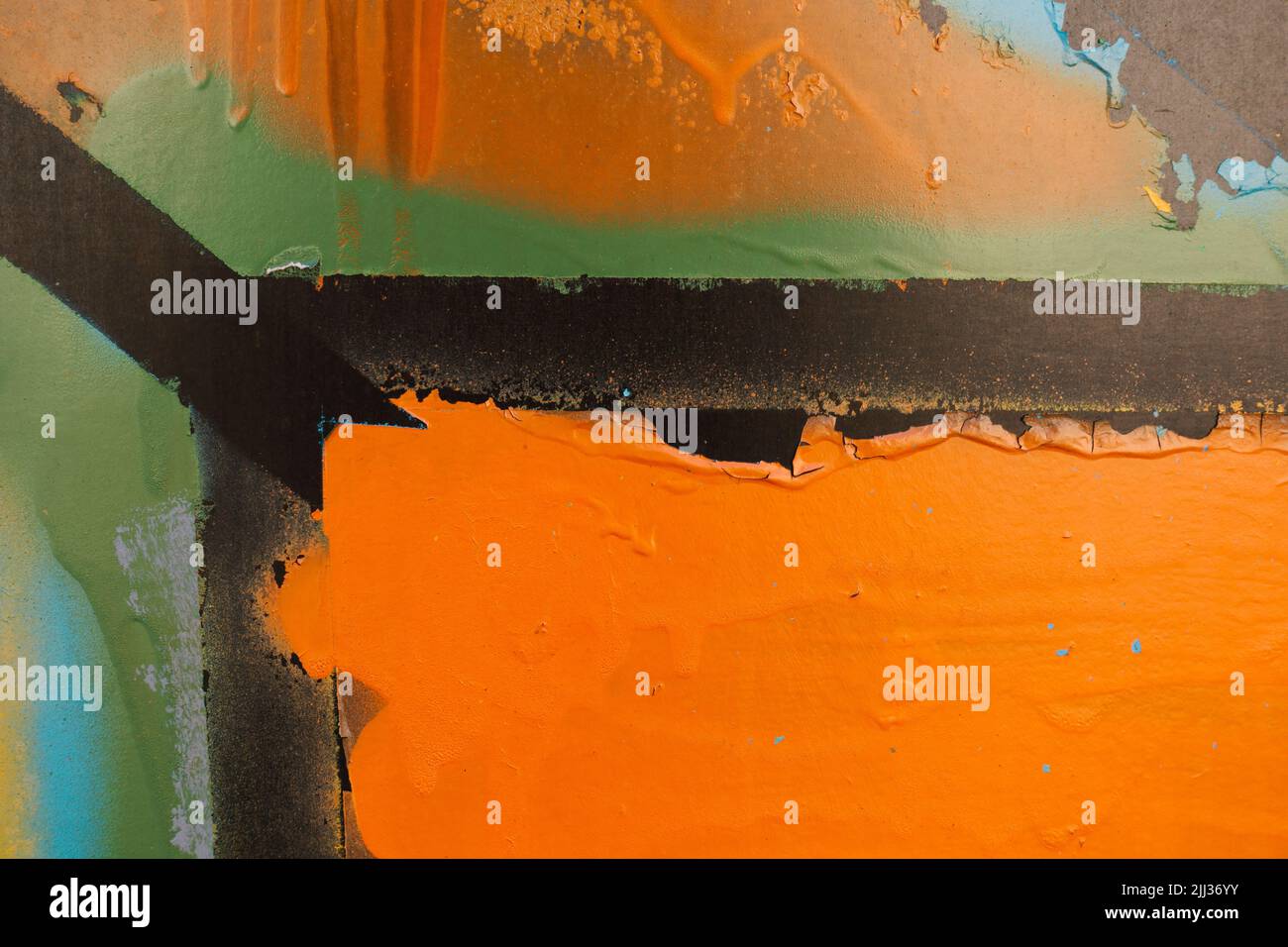 Old abandoned wall with fragment of orange, brown, green colors ...