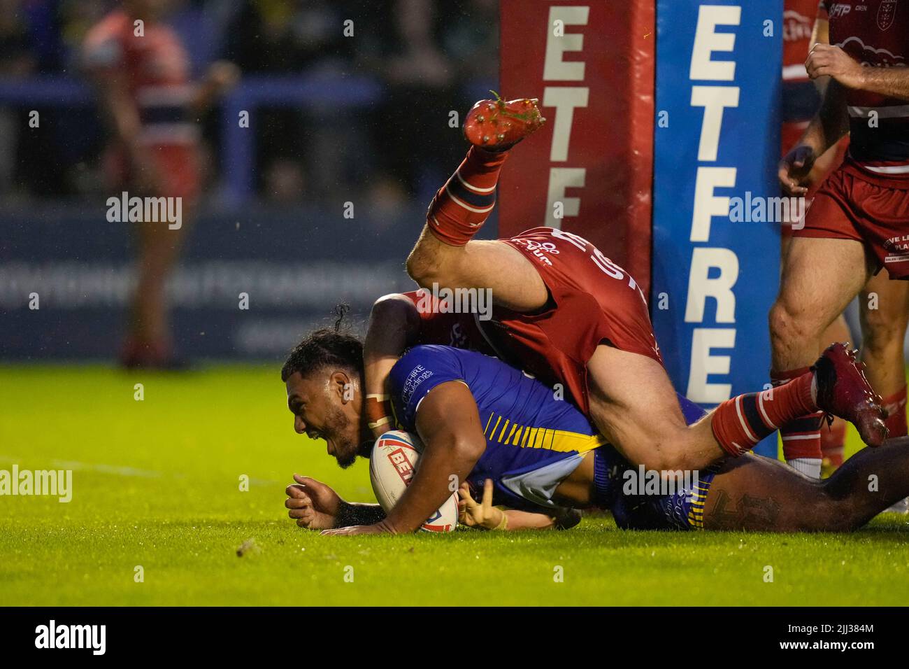 Thomas Mikaele #33 of Warrington Wolves dives over to score Stock Photo ...