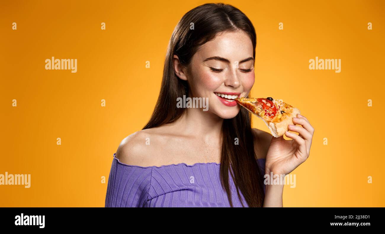 Image of girl smiling while biting slice of pizza, happy face at ...