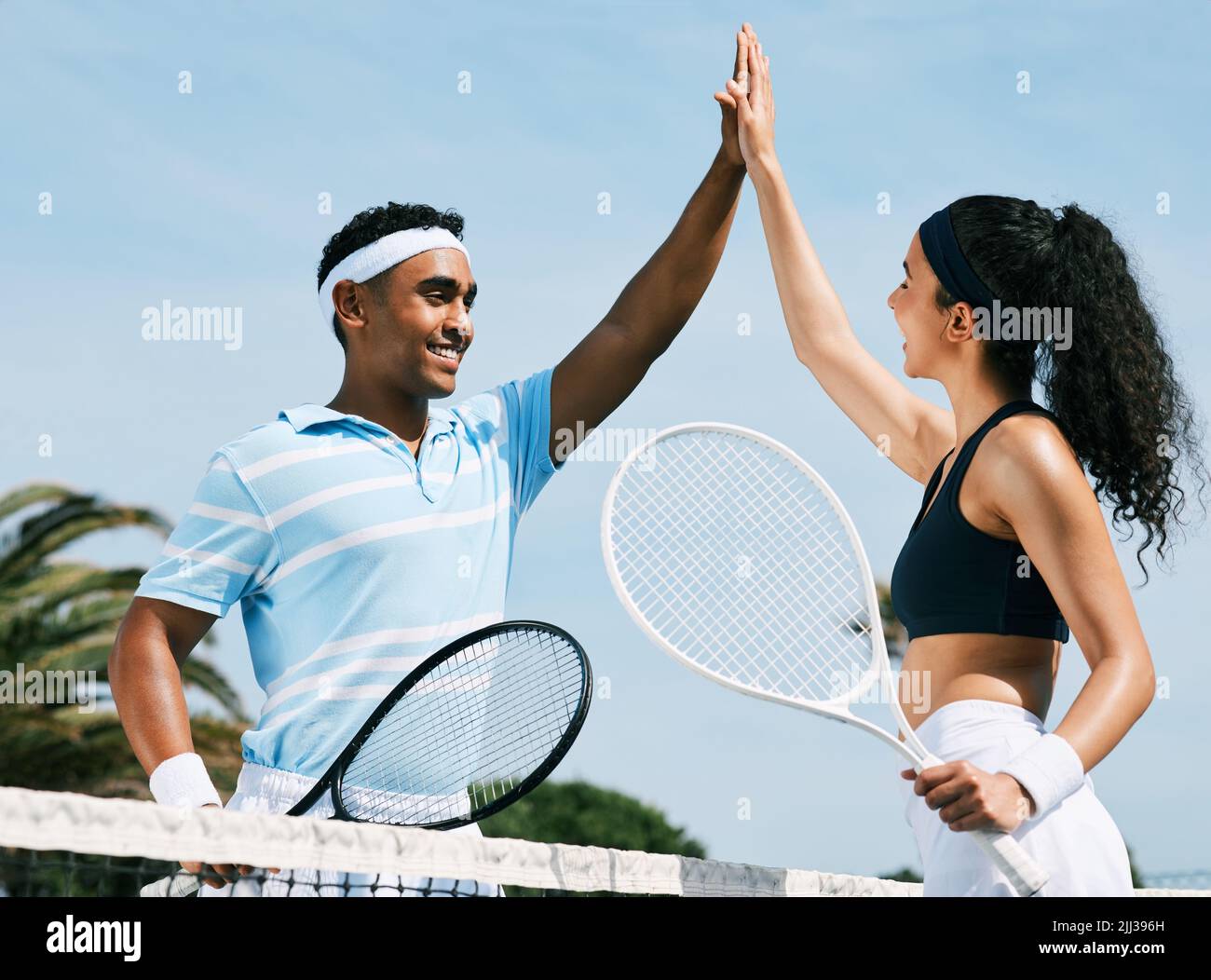 We gave it our all. tennis teammates sharing a high five during a ...