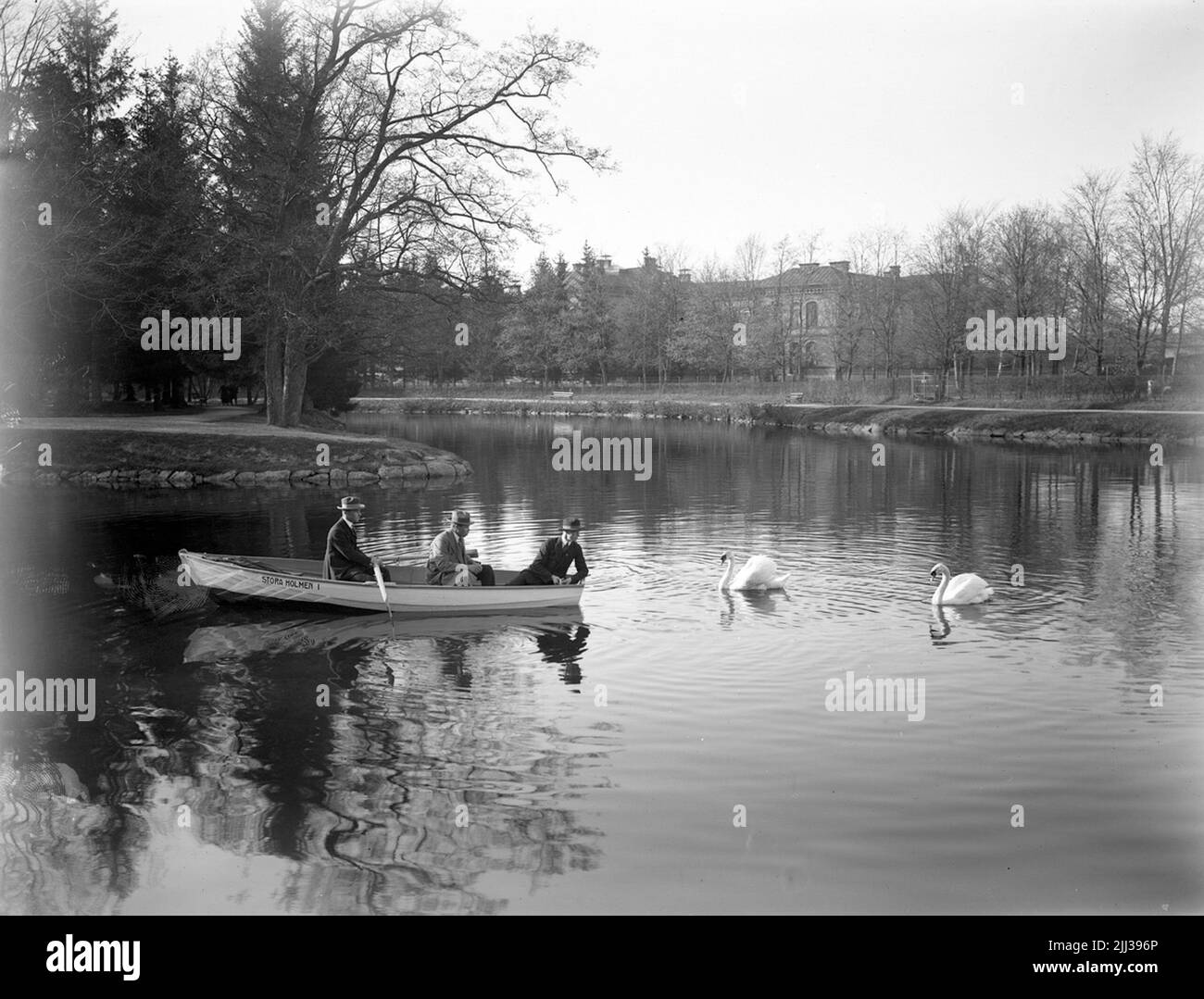 Three people walk on Black and White Stock Photos & Images - Alamy