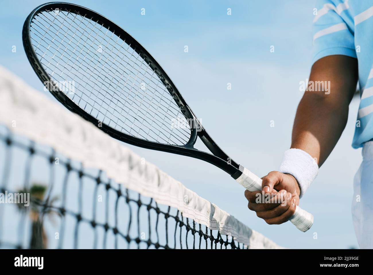 Give it your best shot. an unrecognizable man holding a racket during a ...