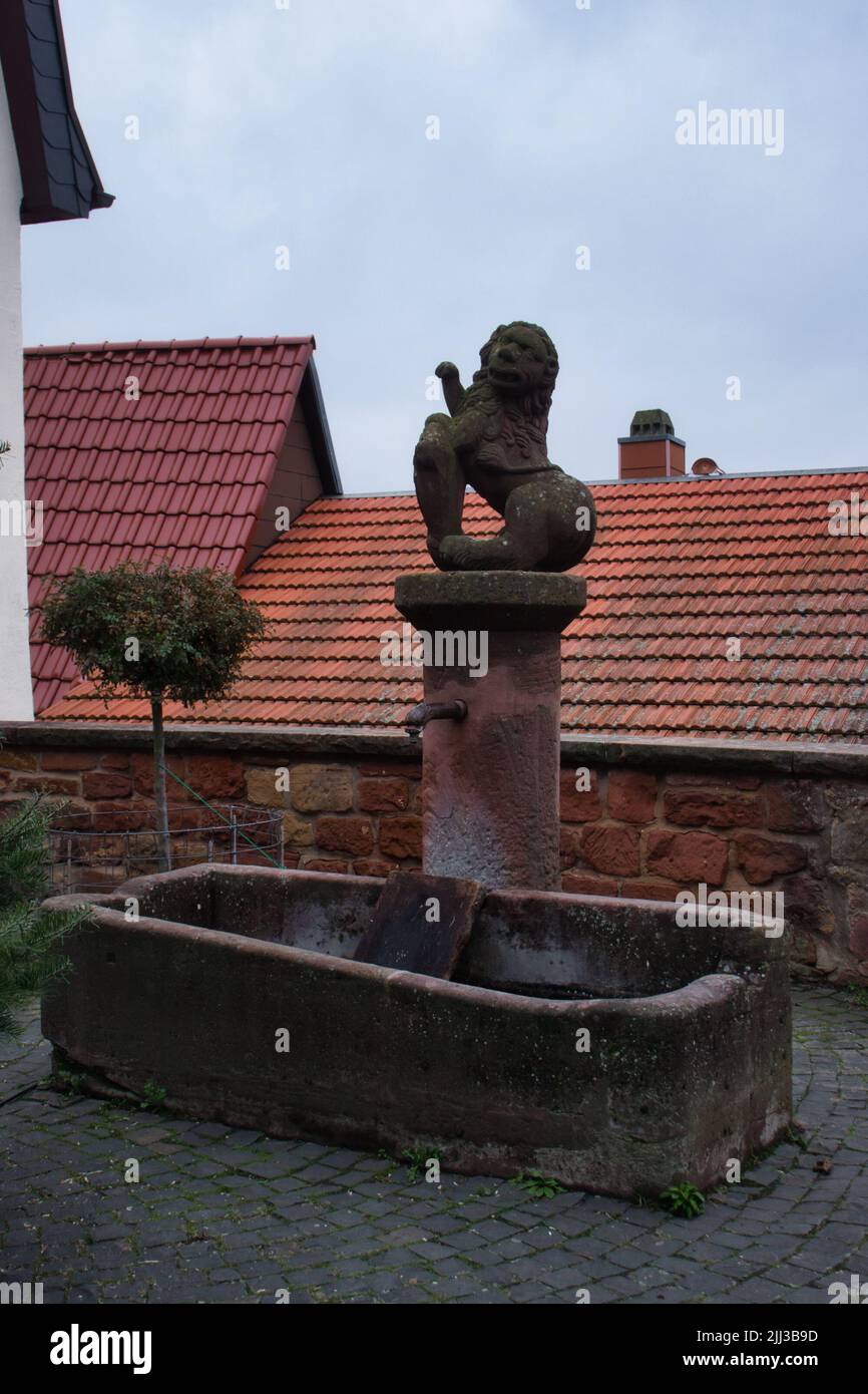 Neuleiningen, Germany - December 2, 2020: Lion statue on a fountain in ...