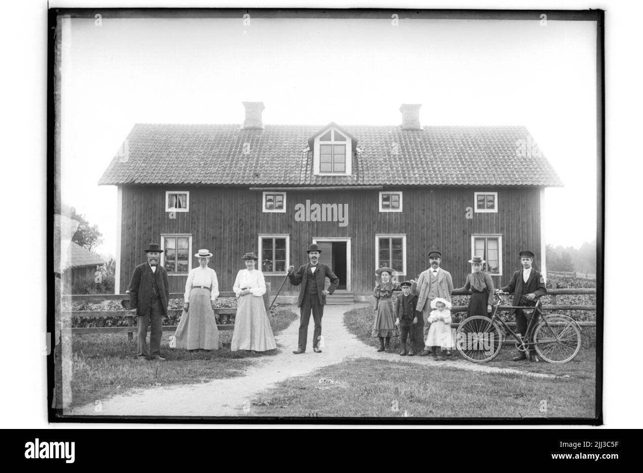 One and a half -storey residential buildings. 10 people in front of the ...