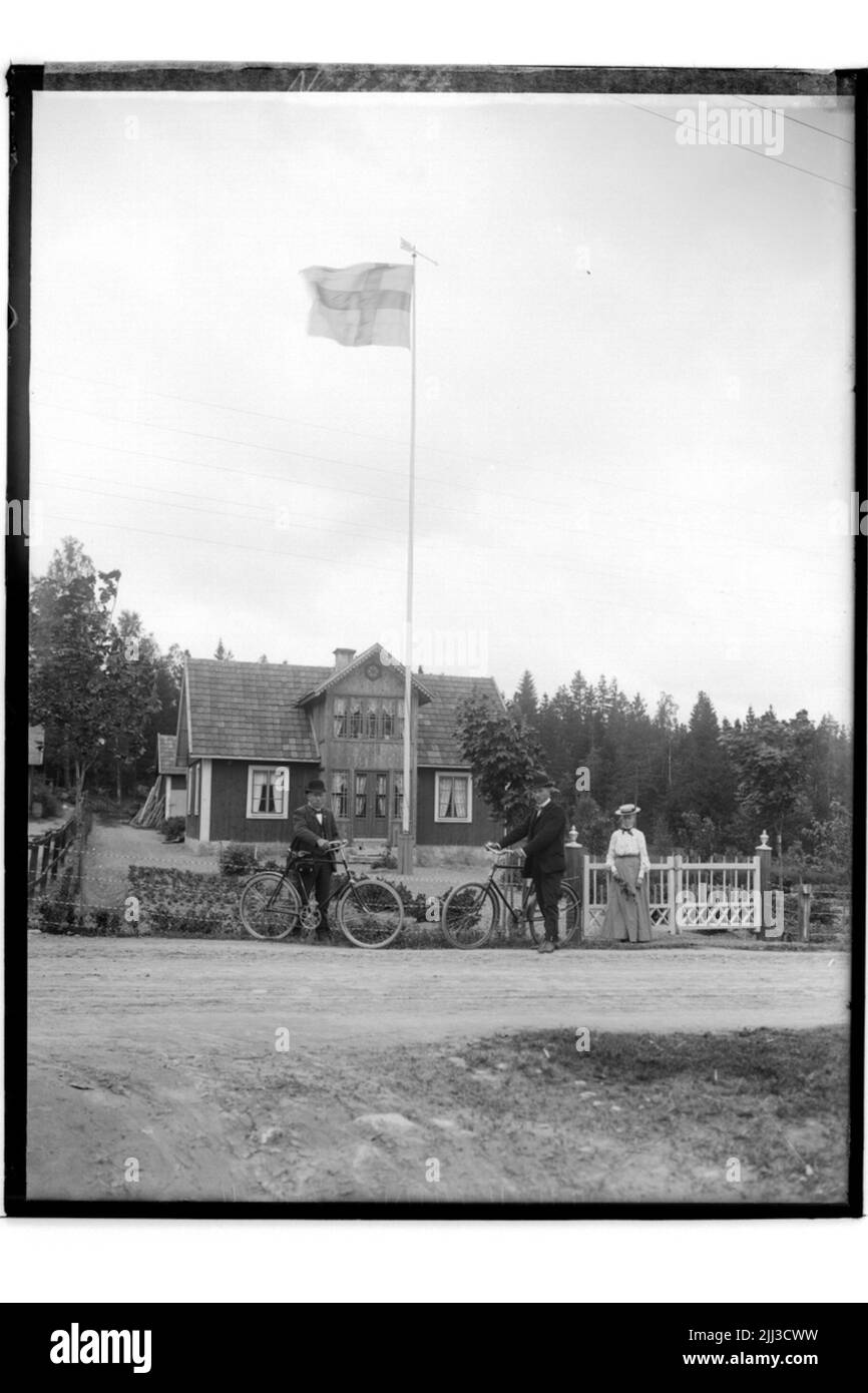One and a half -storey residential buildings.2 men with bicycles and a ...