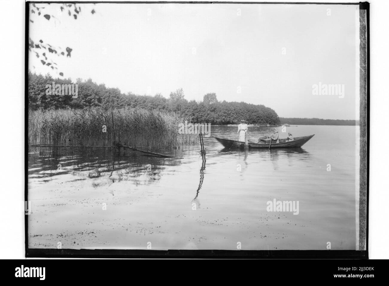 Three people in a rowing boat (Hjälmaresnipa). Wife Anna Sundin Stock ...